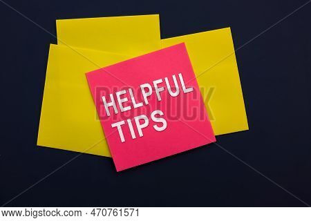 Helpful Tips - Inscription Of A Pink Square Sticky Note Paper On Dark ...