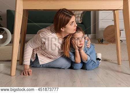 Child Hiding Behind Mother
