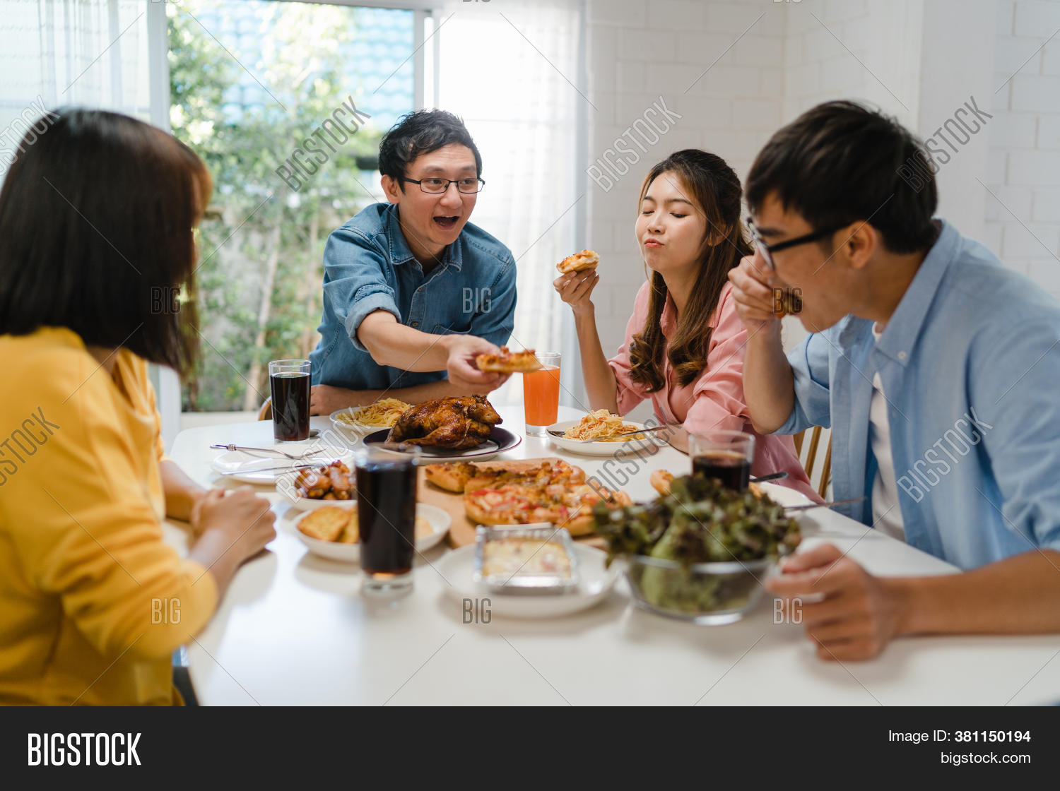 Family Eating Pizza At Table