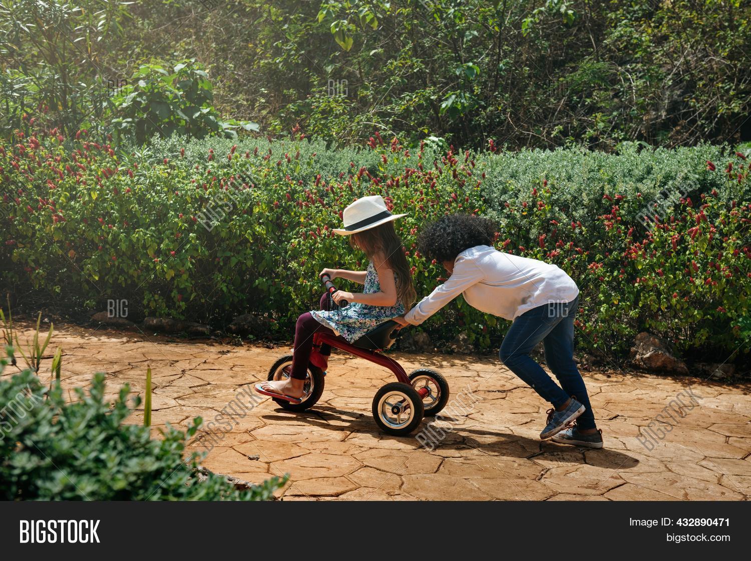 Kids Playing Tricycle Image & Photo (Free Trial) | Bigstock
