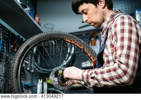 Bicycle Mechanic Fixing Cycle Wheel In Repair Shop. Velocipede Service ...