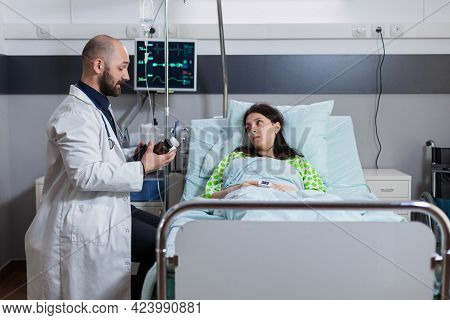 Physician Medic Monitoring Sick Patient During Medical Appointment In ...