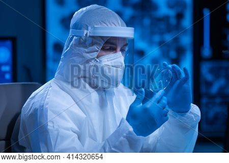 Doctor In Protective Suit Is Doing A Science Experiments And Developing ...