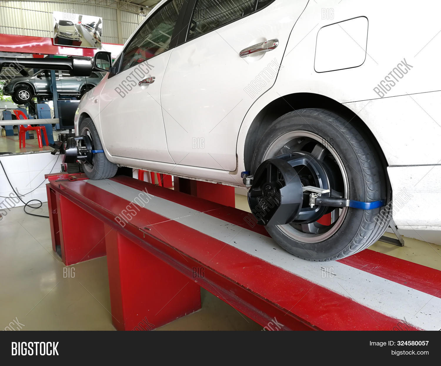 Car Checks Wheel Image & Photo (Free Trial) | Bigstock