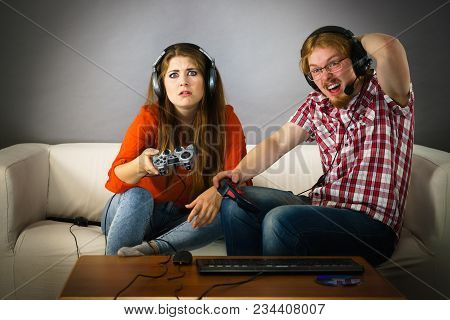 Couple Enjoying Leisure Time By Playing Video Games Together, Man And ...