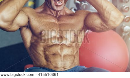 Fit Man Training Training Abs Muscles At Gym. Pumping Up Abdominal ...