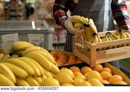 Hands Of A Supermarket Seller Worker In An Apron Arranging Citrus ...