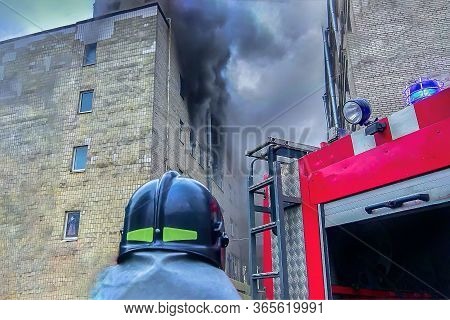 Firefighter In Front Of A Fire In A High-rise Trade Building, Fighting ...