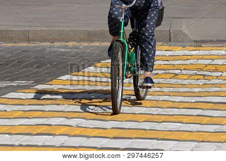 Woman Riding A Bike On A City Street. Female Legs And Bicycle Wheels On ...
