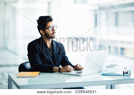 Portrait Of A Busy Indian Guy Multitasking, Taking Notes, Reading Paper ...