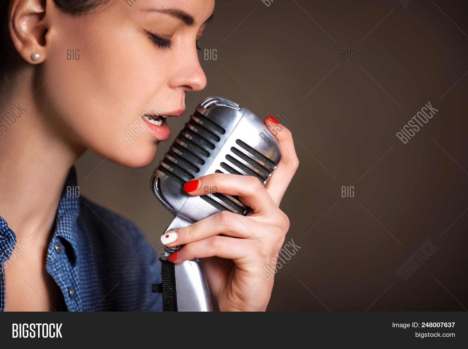 Woman Singing Into Microphone