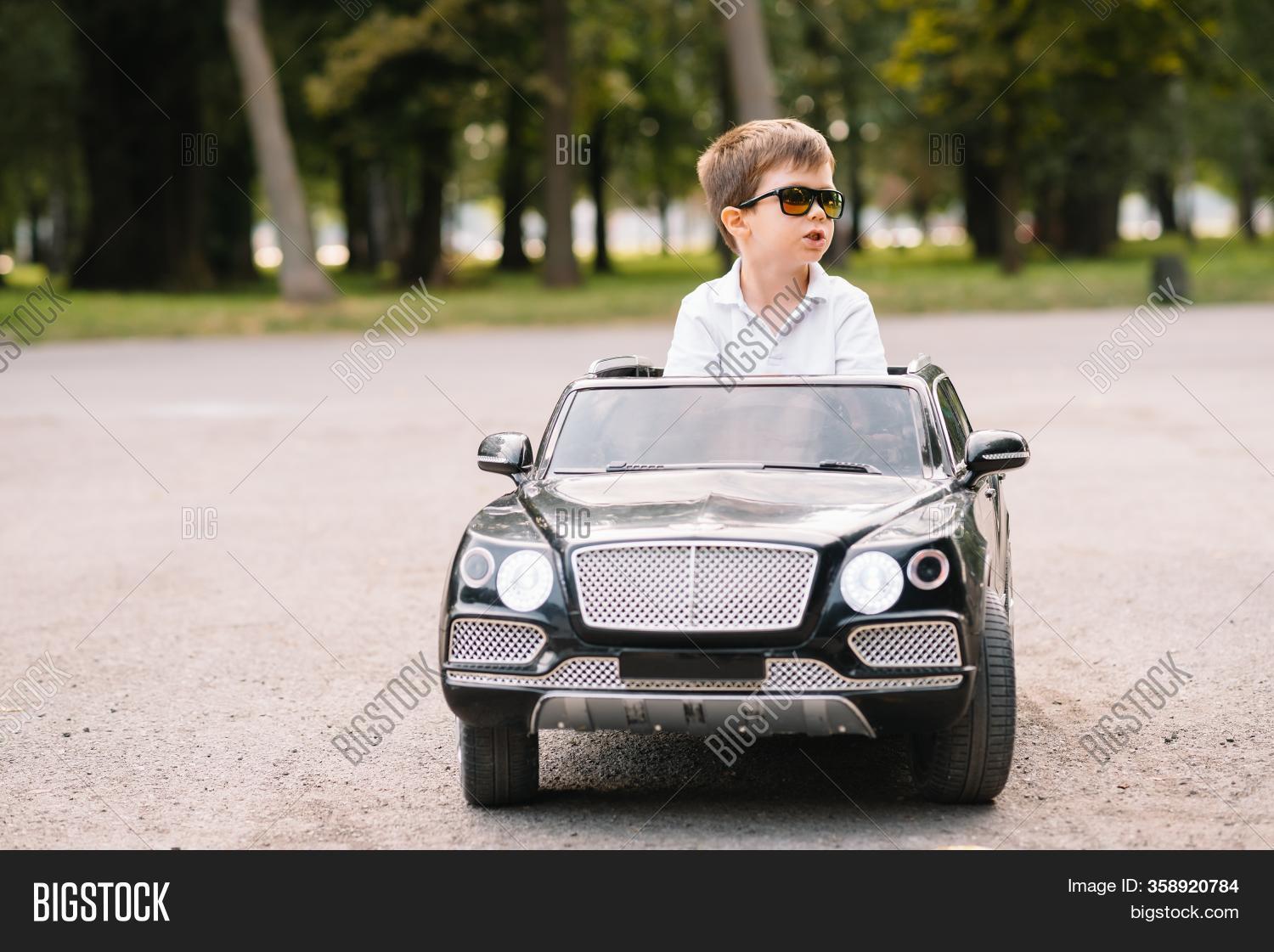 Cute Boy Riding Black Image & Photo (Free Trial) | Bigstock
