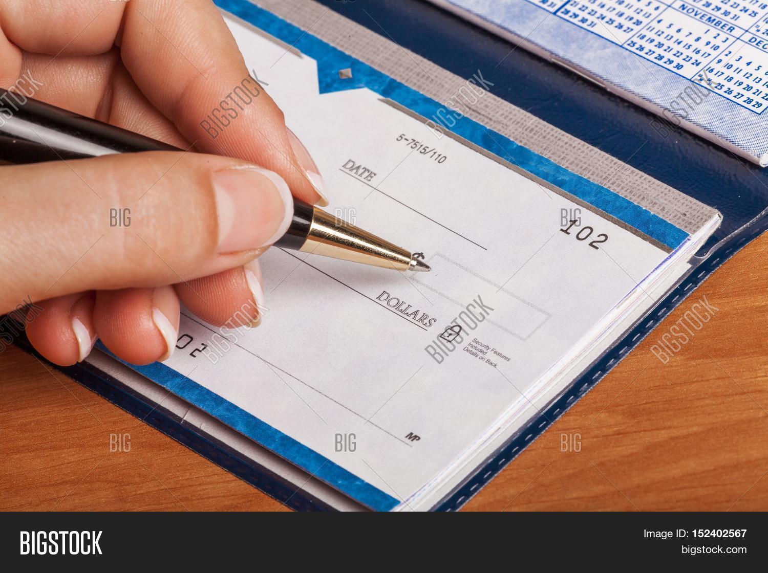 Woman's Hand Writing a Check - Close Up Stock Photo & Stock Images ...