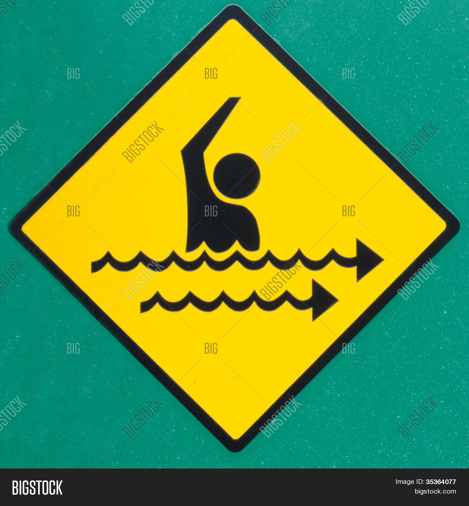 Rip current hazard symbol warning sign on green Stock Photo & Stock ...