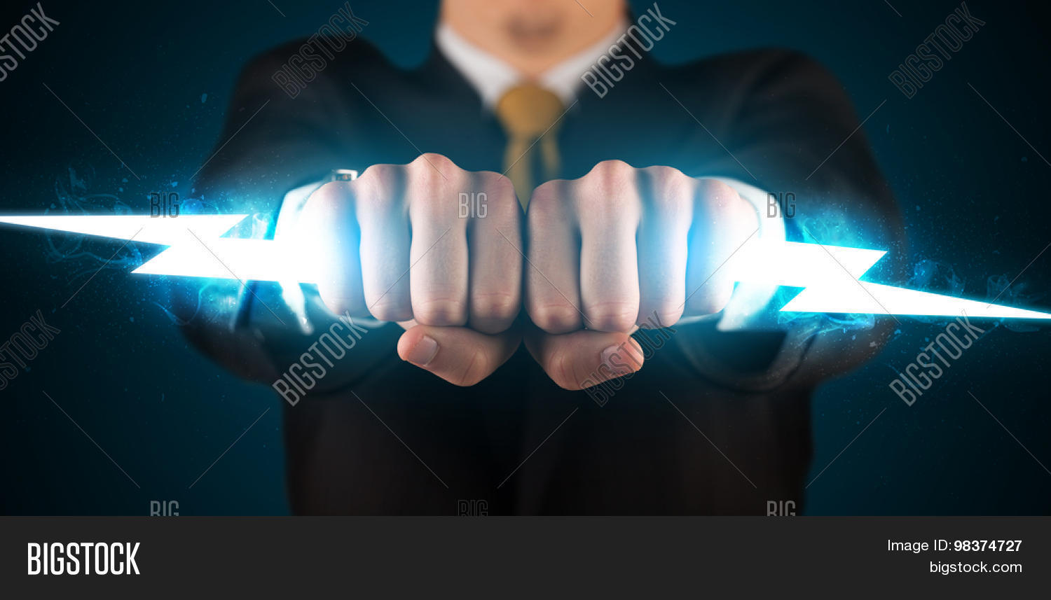 Business man holding glowing lightning bolt in his hands concept Stock ...