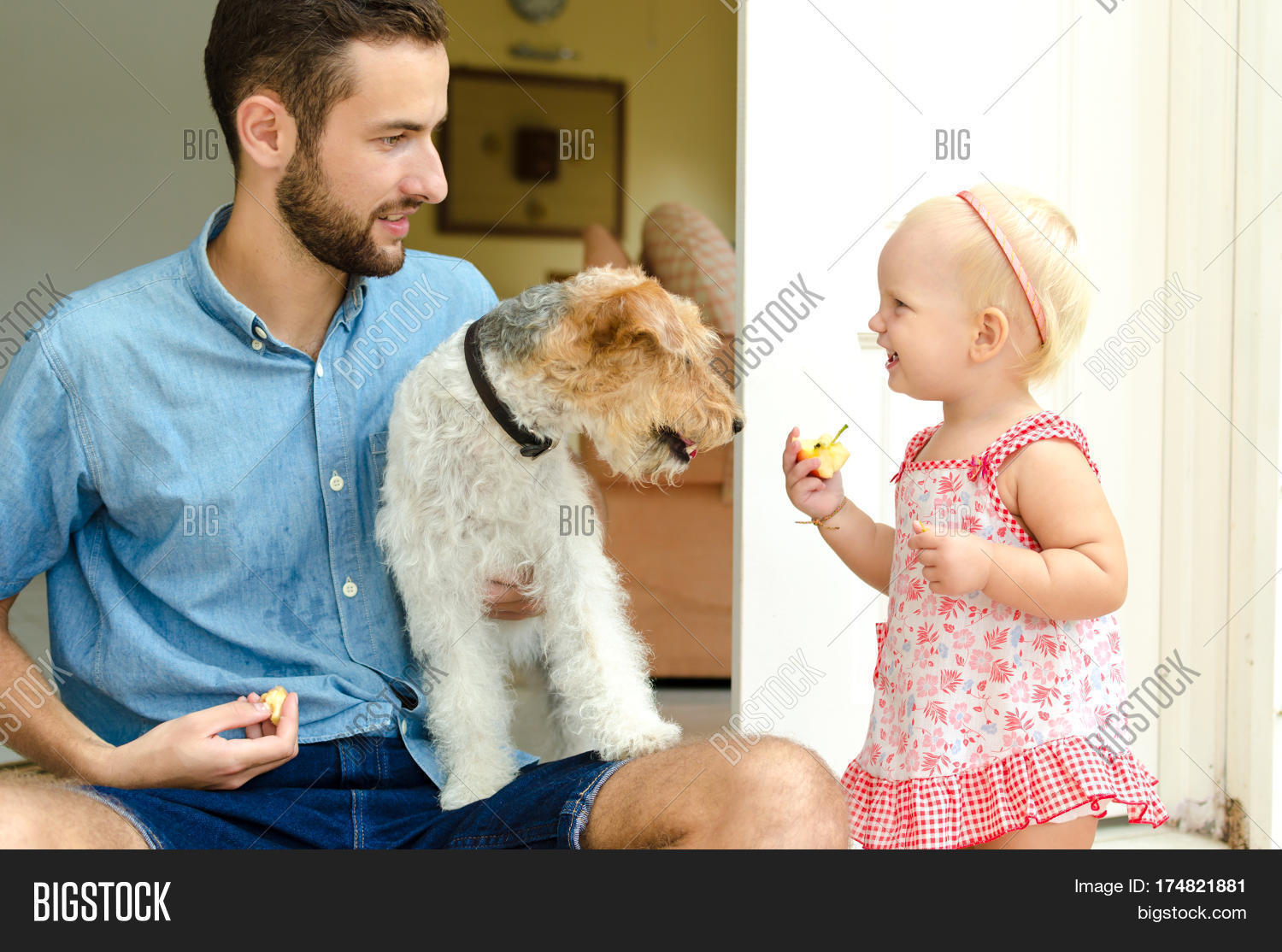 Dad and daughter and their dog. A man and a girl near her home on the ...