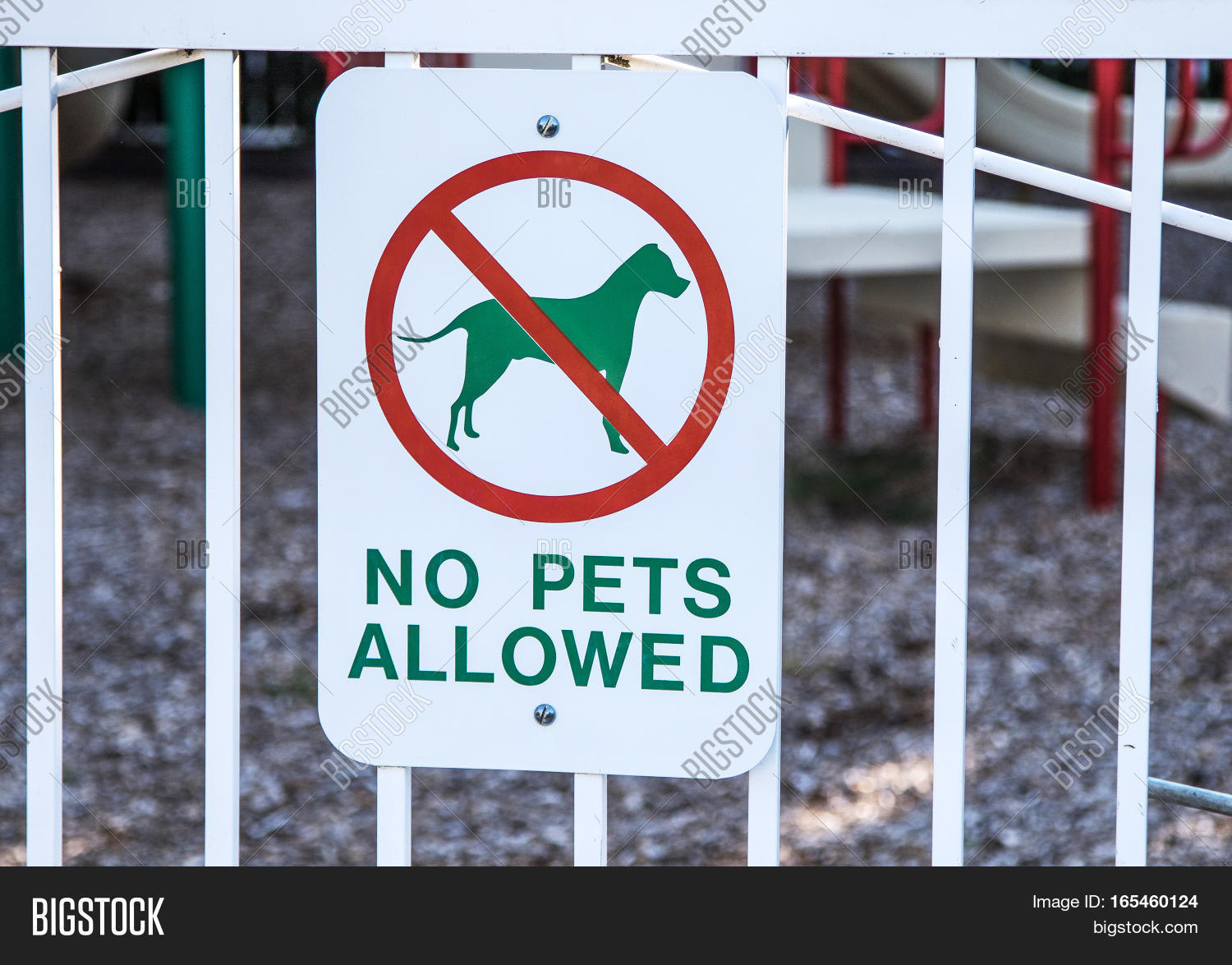 A "No pets allowed" allowed sign on a fence of a children playground ...